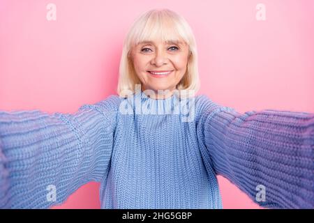 Portrait of beautiful trendy cheery grey-haired woman demonstrating ...
