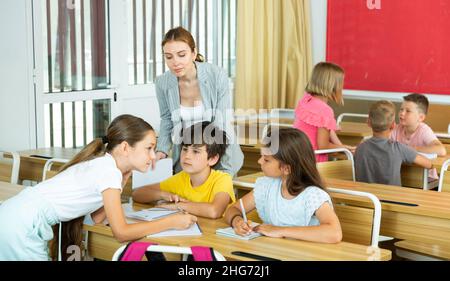 Children performing group tasks Stock Photo - Alamy