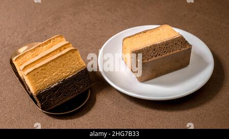 a dessert in the form of a piece of brownie cake served on the table ...