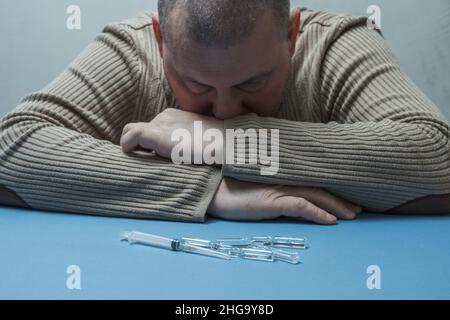 Medicine and health concept. A man looks through a magnifying glass at ...