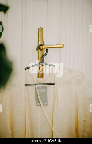 Beautiful delicate dress with a price tag on a hanger, stylist Stock ...
