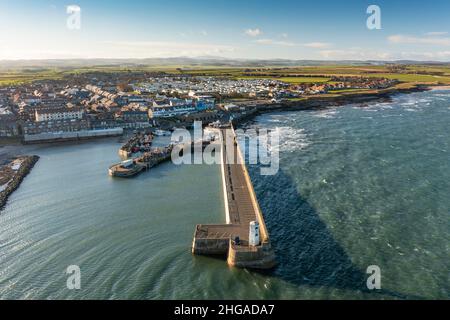 Aerial view from drone of Seahouses fishing harbour in Northumberland ...
