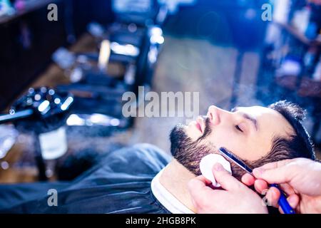 arabic handsome bearded man getting haircut at barbershop Stock Photo ...