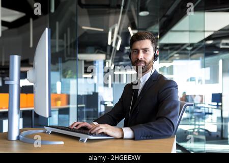 Successful businessman uses headset for online conference, happy man ...