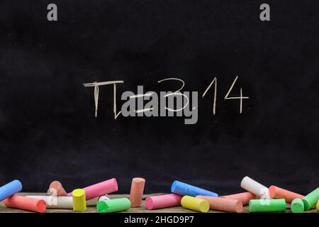 Pi number, mathematical constant chalk drawing on a school black board ...