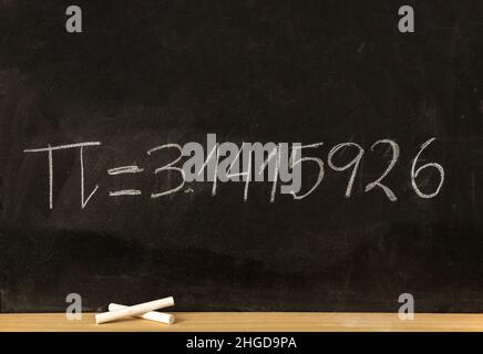 Pi number, mathematical constant chalk drawing on a school black board ...
