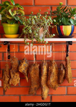 Strips of meat hang to dry in the sun ready to be grilled at a Bangkok ...