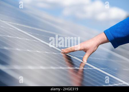 Engineer's hand on solar panel Stock Photo - Alamy