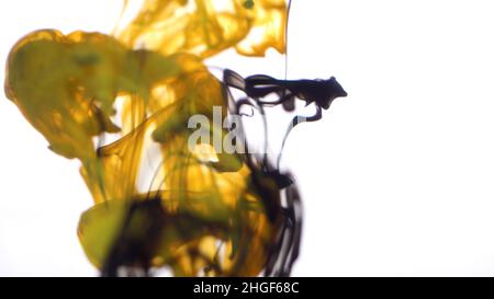 Colorful yellow ink falling down Stock Photo - Alamy