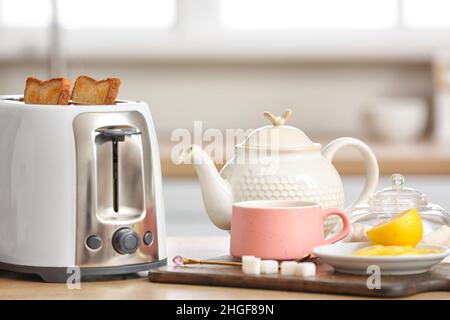 White toaster with tasty food, drink and vase on counter in kitchen Stock Photo - Alamy