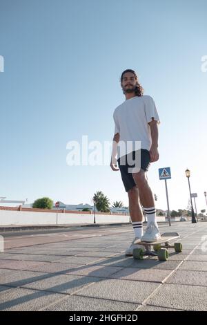Caucasian man with long beard standing over isolated background looking ...