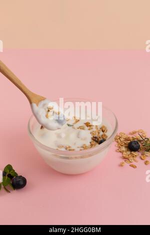 scooping yogurt with a spoon, pink background Stock Photo - Alamy