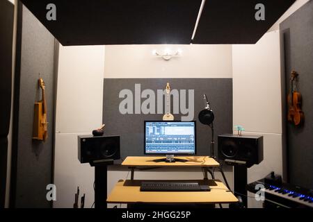 Music studio full of instruments and pc display Stock Photo - Alamy