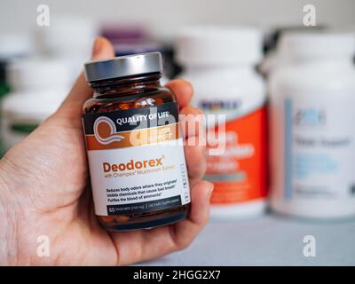 Jar with Deodorex capsules in female hand Stock Photo - Alamy