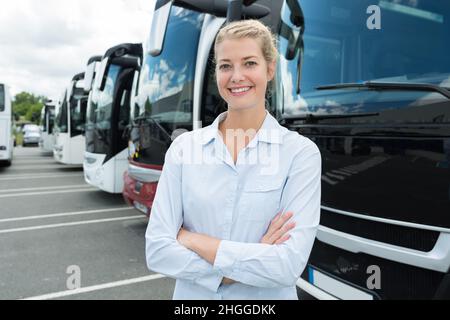 female bus operator posing in front of buses Stock Photo - Alamy