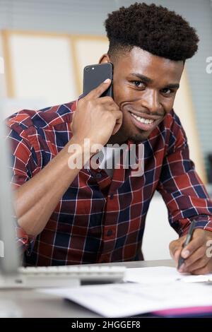 Young Businessman Looking At Invoice While Doing Online Banking On ...