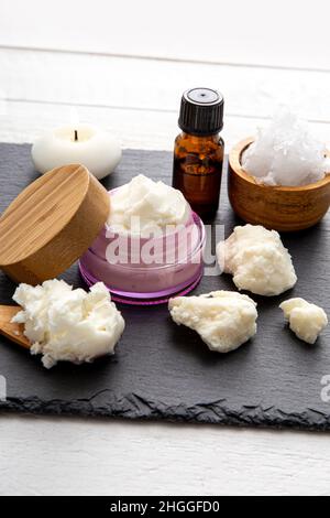 Spa set with shea butter on color background Stock Photo - Alamy