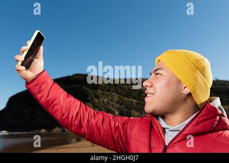 Adult hispanic man wearing winter sweater over isolated background ...