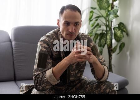 Depressed and sad soldier in green uniform with trauma after war Stock ...