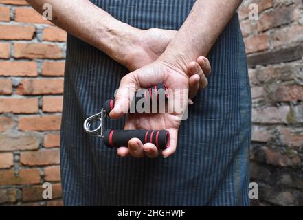 Southeast asian, Myanmar old man gripping hand exercise gripper Stock ...