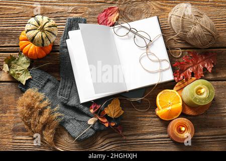 Blank book with eyeglasses and autumn decor on wooden background with ...