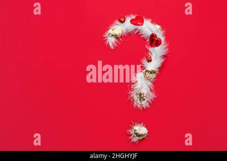 Question mark made of feathers and little hearts on color background ...