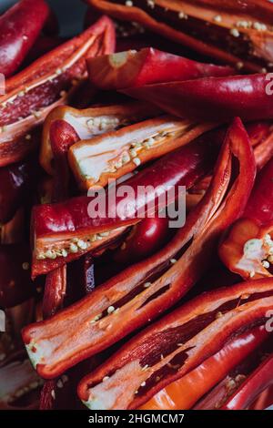 Single fresh chopped red chili pepper is isolated on white background ...