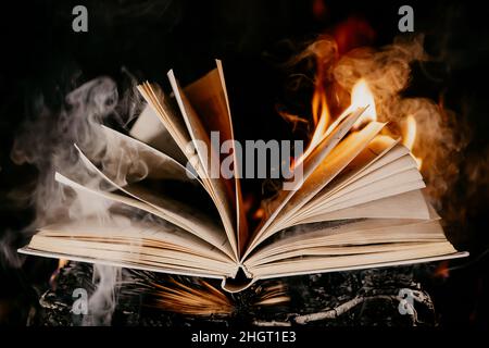 Open burning diary on black background. Notebook with flame coverage ...