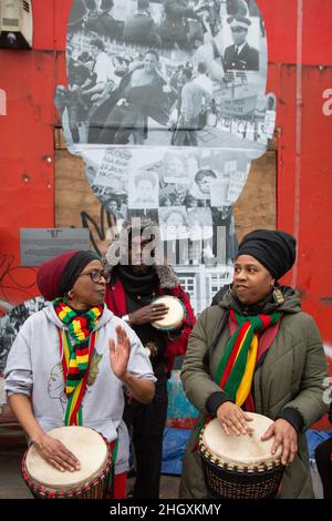 People play drums during the unveiling of mural honoring those who died ...