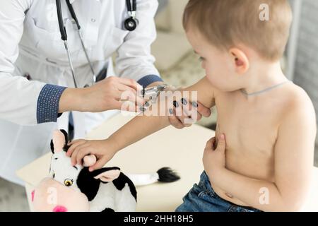 Nurse giving intramuscular injection of medicine into patients buttock ...