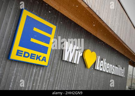 EDEKA company logo with the slogan WE LIVE FOOD at a branch, market in ...