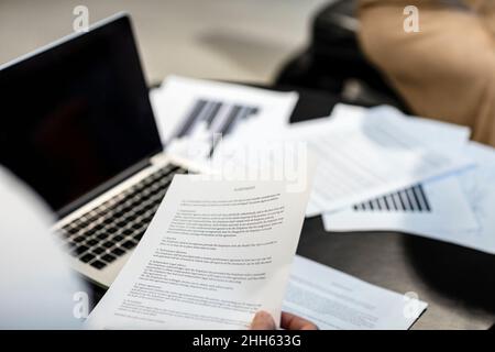 Businessman holding document in office Stock Photo - Alamy