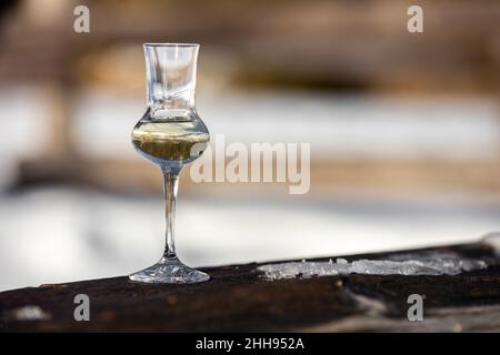 Bokeh picture of a flavored Grappa (Schnapps) glass in Cortina d ...