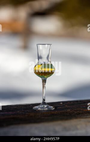 Bokeh picture of a flavored Grappa (Schnapps) glass in Cortina d ...