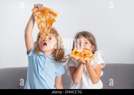 Funny kids eating pizza. Cute children little girl and boy eating tasty ...