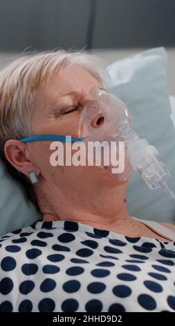 Medical team helping patient with respiratory disease, using oxygen ...