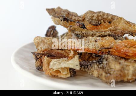 Deep-fried yellow pollack peel on a white background Stock Photo - Alamy
