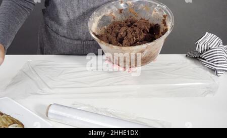 Step by step. Wrapping cookie dough into the plastic wrap to bake ...