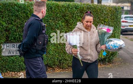 A member of public with flowers on Thirlmere Avenue in Stretford ...