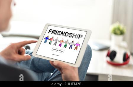 Tablet screen displaying a friendship concept Stock Photo - Alamy