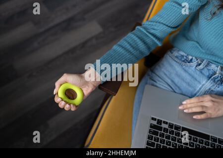 Female hand exercising with silicone grip ring for hand flexibility and ...