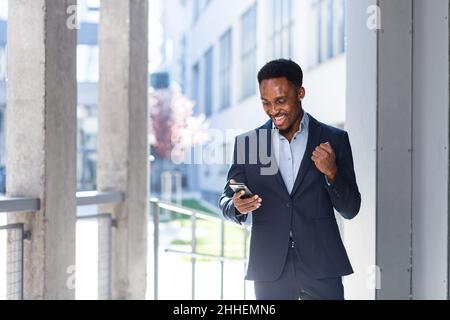 Exited African American Businessman Celebrating Achievement looking at ...