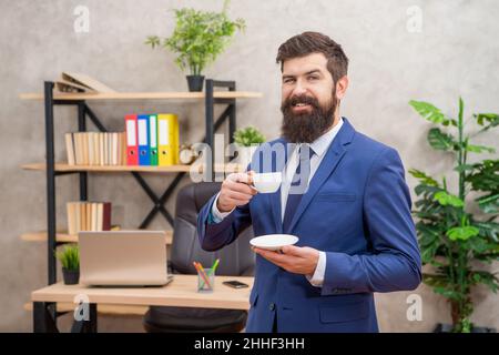 happy brutal ceo in businesslike suit has lunch break with coffee cup ...