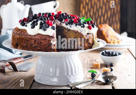Christmas cake decorated with blueberry, cranberry and mint. Flat lay ...