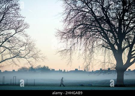 A pedestrian is seen walking through the mist in a park in Ilford, East ...