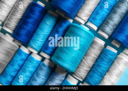 Closeup view of spools with grey and blue sewing threads Stock Photo ...