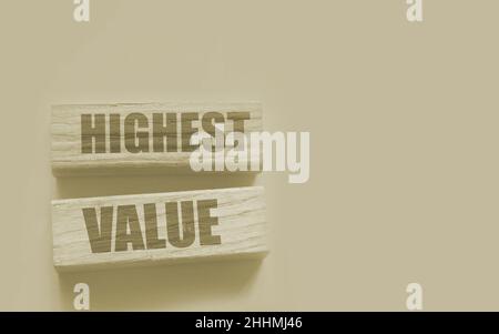 Highest values words on wooden building blocks isolated on yellow ...