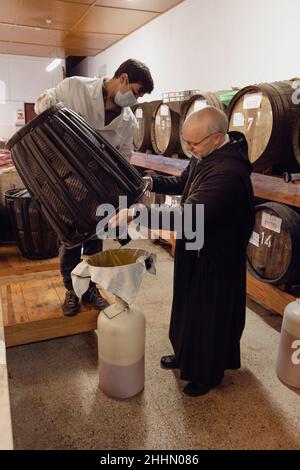 Benedictine monks preparing artisanal liqueur at the Monastery of Saint ...