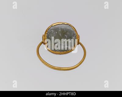 Gold hoop with picrolite stone in gold setting. Culture: Cypriot ...