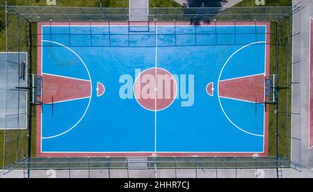 Multisport court seen at 90 degrees from a drone in blue and red colors ...